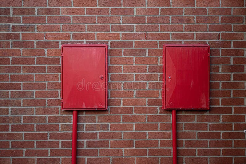 Two Red Square Boxes Affixed To a Brick Wall Stock Image - Image of ...