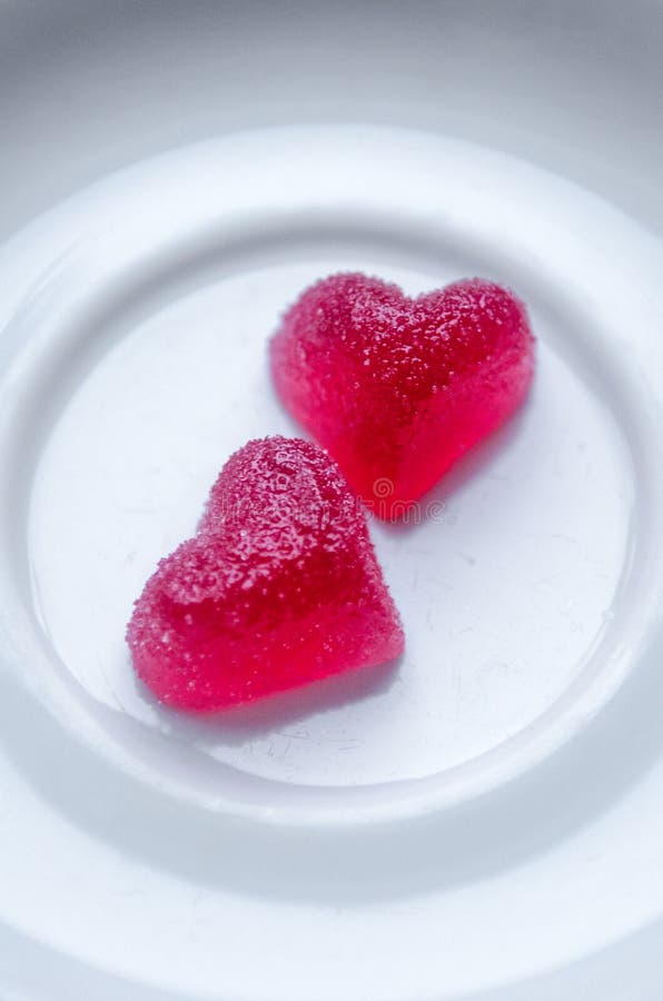 Two Red Sugar Marmalade Candies in Shape of a Heart on a White Plate ...