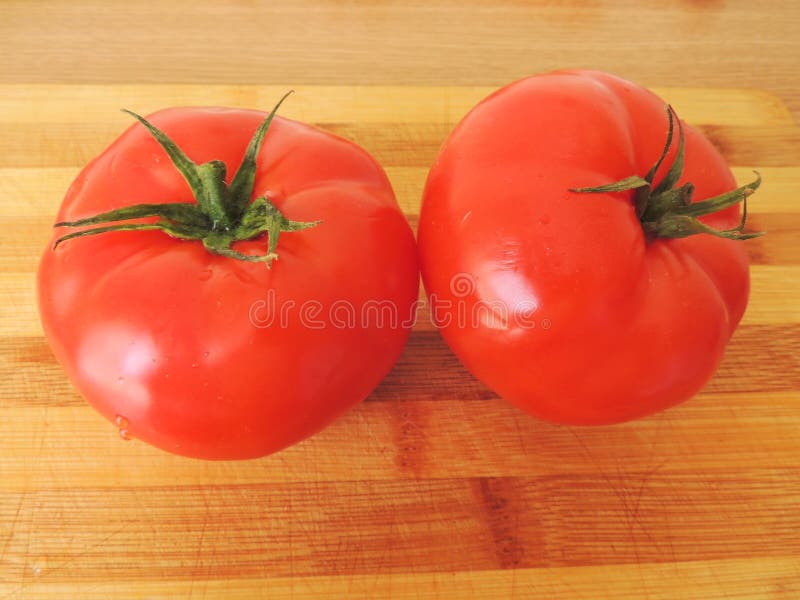 Two Red Tomatoes on a Cutting Board. Stock Photo - Image of nature ...