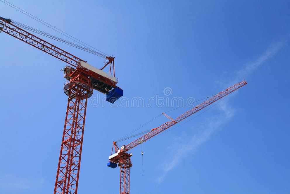 Two red tower cranes stock image. Image of equipment - 26557161