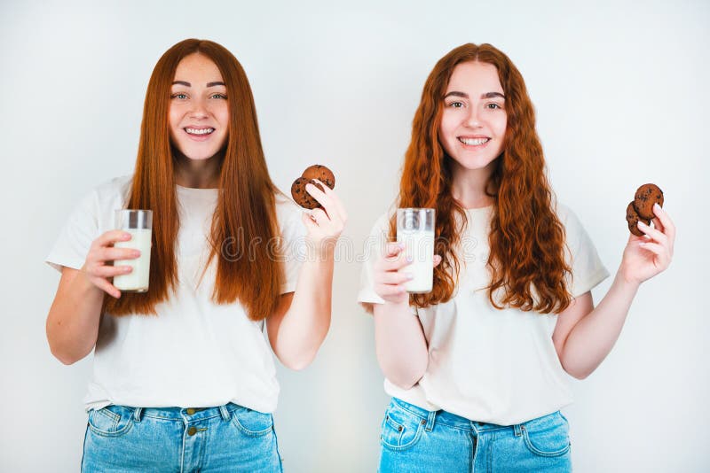 Two Redheaded Happy Women One With Remote Control Another With Popcorn
