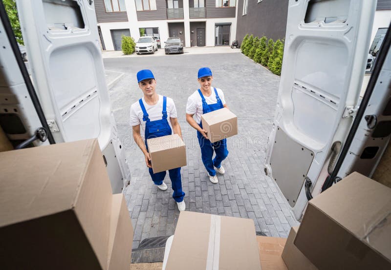 Two Removal Company Workers are Loading Boxes into a Minibus. Stock ...