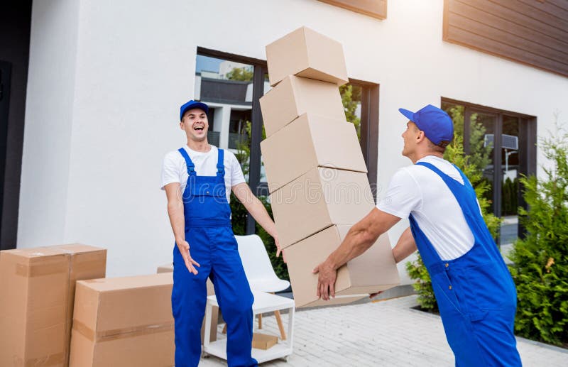Two Removal Company Workers are Loading Boxes into a Minibus. Stock ...