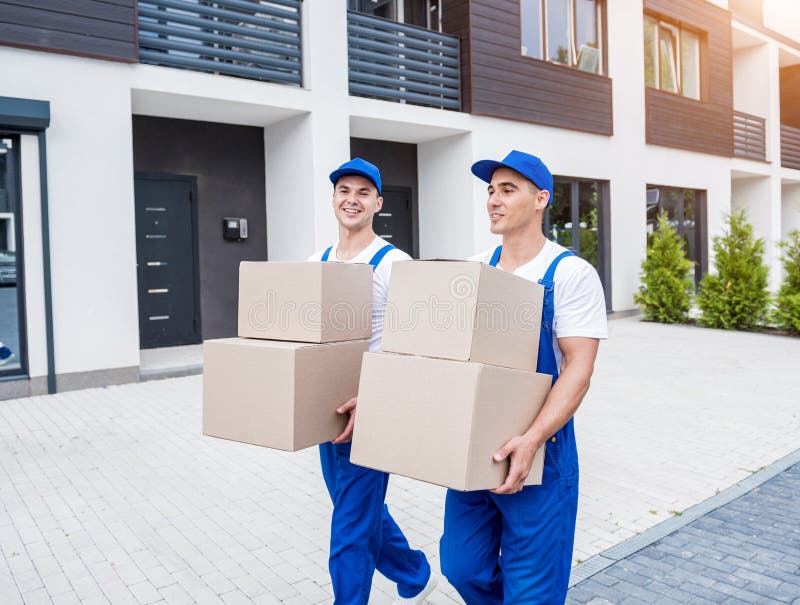 Two Removal Company Workers are Loading Boxes into a Minibus. Stock ...