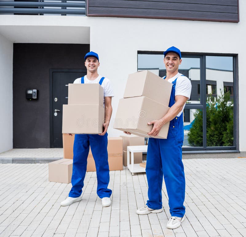 Two Removal Company Workers are Loading Boxes into a Minibus. Stock ...