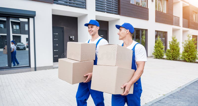 Two Removal Company Workers are Loading Boxes into a Minibus. Stock ...