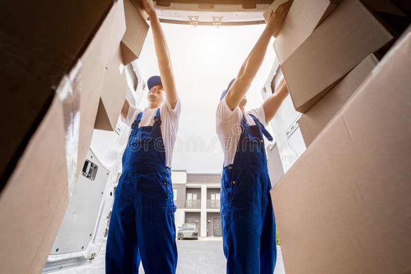 Two Removal Company Workers Have a Break while Sitting on the Step ...