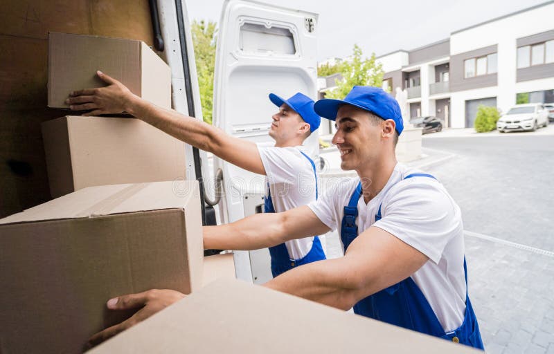 Two Removal Company Workers Unloading Boxes from Minibus Stock Photo ...
