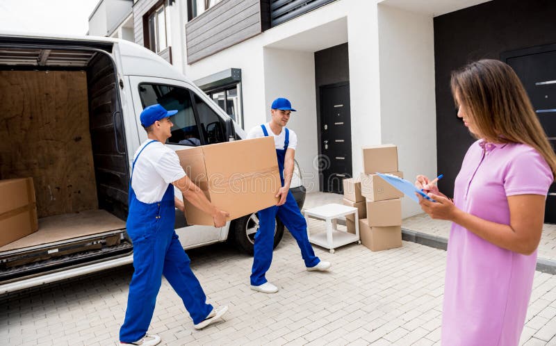Two Removal Company Workers Unloading Boxes from Minibus into Customer ...