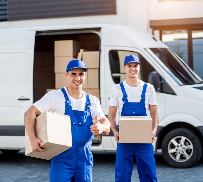 Two Removal Company Workers Unloading Boxes from Minibus into New Home ...