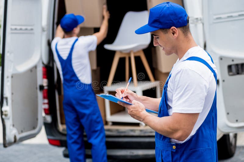 Two Removal Company Workers Unloading Boxes from Minibus into New Home ...
