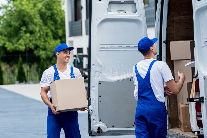 Two Removal Company Workers Have a Break while Sitting on the Step ...