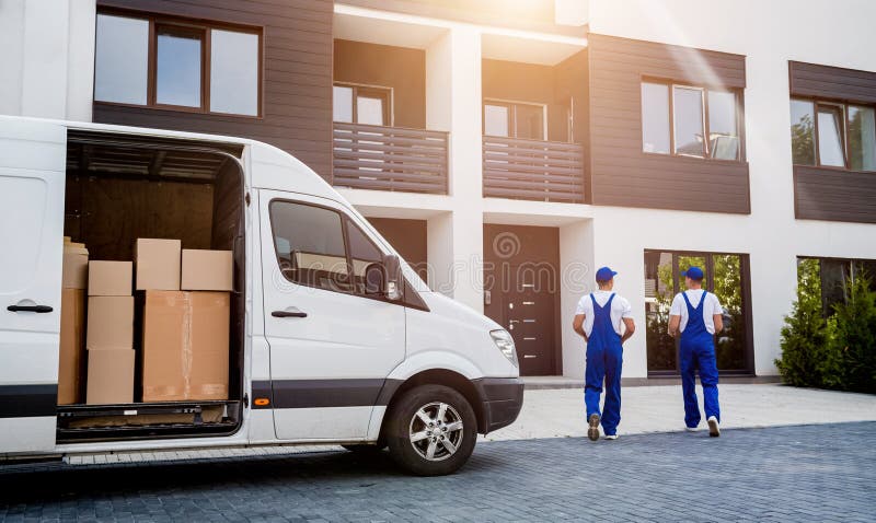 Two Removal Company Workers Unloading Boxes from Minibus into New Home ...
