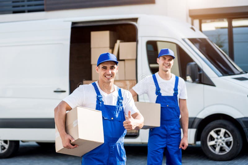 Two Removal Company Workers Unloading Boxes from Minibus into New Home ...