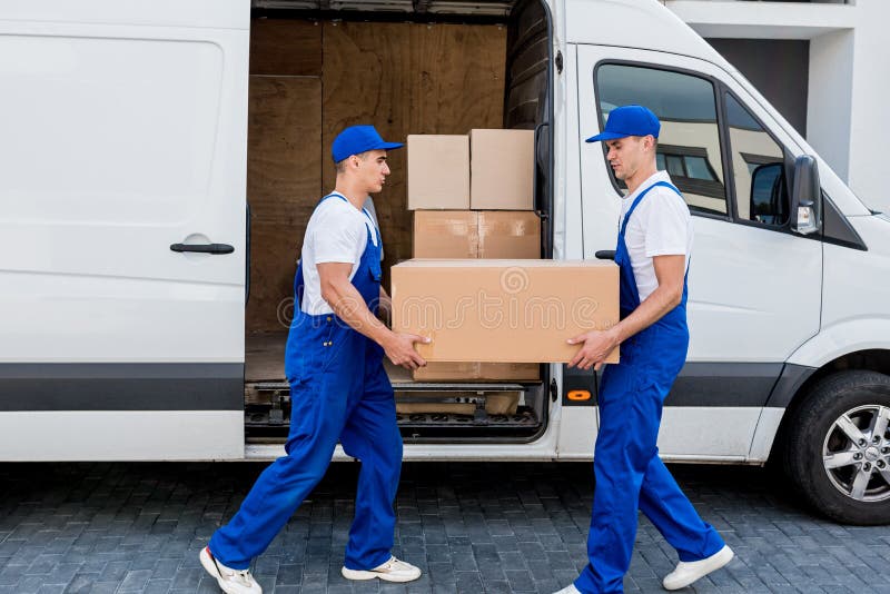 Two Removal Company Workers Unloading Boxes from Minibus into New Home ...
