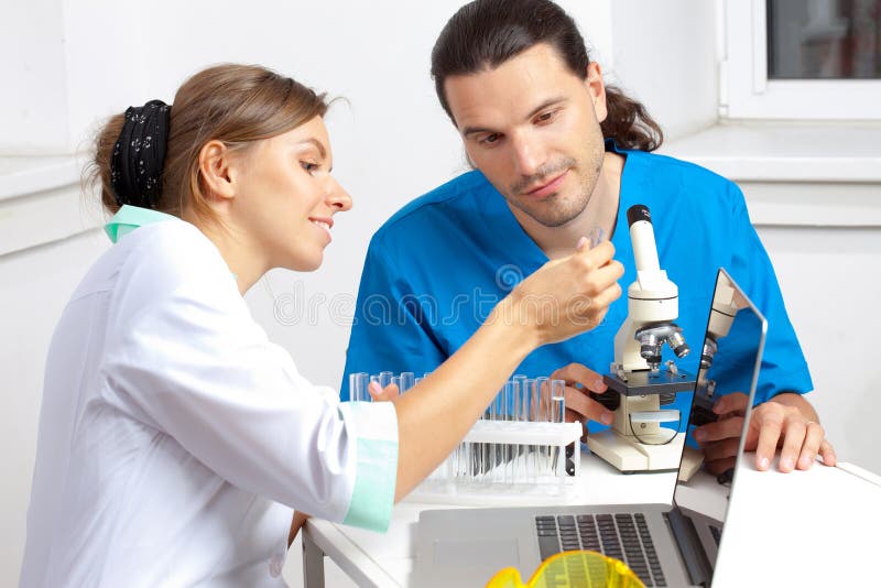 Two Researchers are Looking at a Test Tube Stock Image - Image of ...