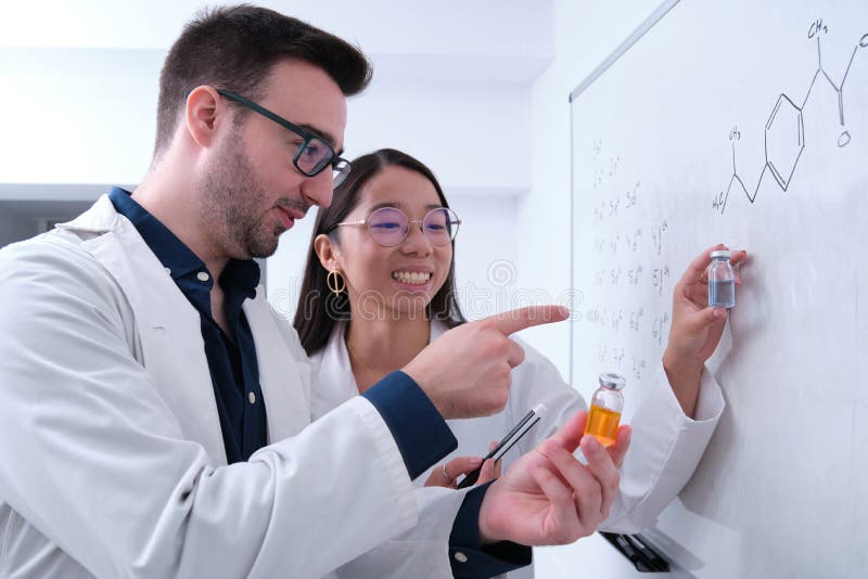 Two Researchers Smiling and Studing Two Medicine Vials. Stock Image ...