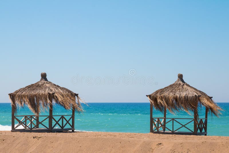 Two Rest Shacks on Tropical Beach on the Shore of the Ocean Stock Photo ...
