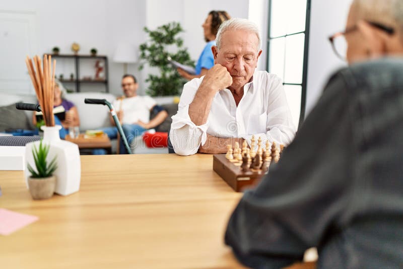 Two Retired Man Smiling Happy Playing Chess at Nurse Home Stock Photo ...