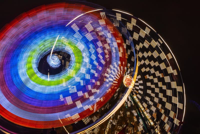 Two Rides in Motion in Amusement Park, Night Illumination. Long ...