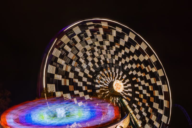 Two Rides in Motion in Amusement Park, Night Illumination. Long ...