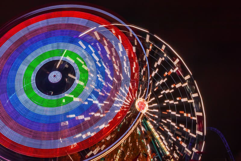 Two Rides in Motion in Amusement Park, Night Illumination. Long ...