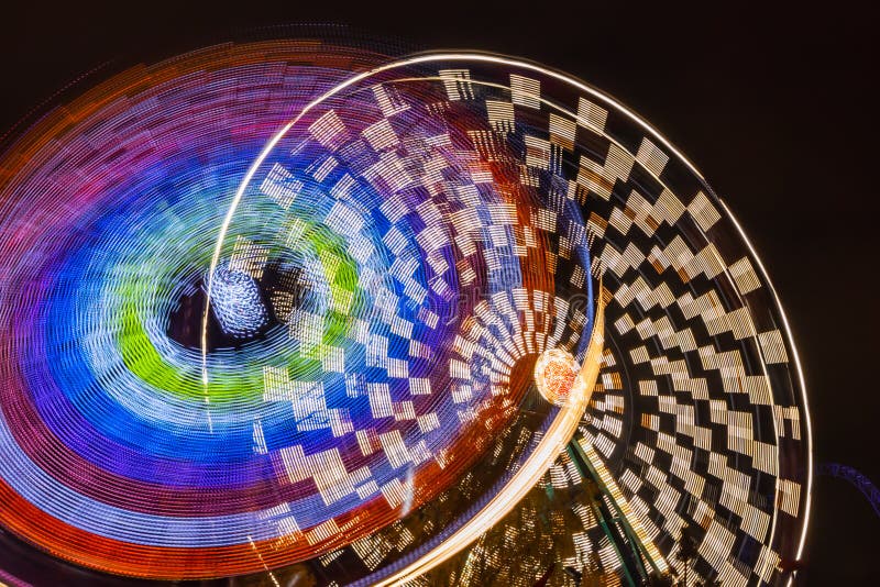 Two Rides in Motion in Amusement Park, Night Illumination. Long ...