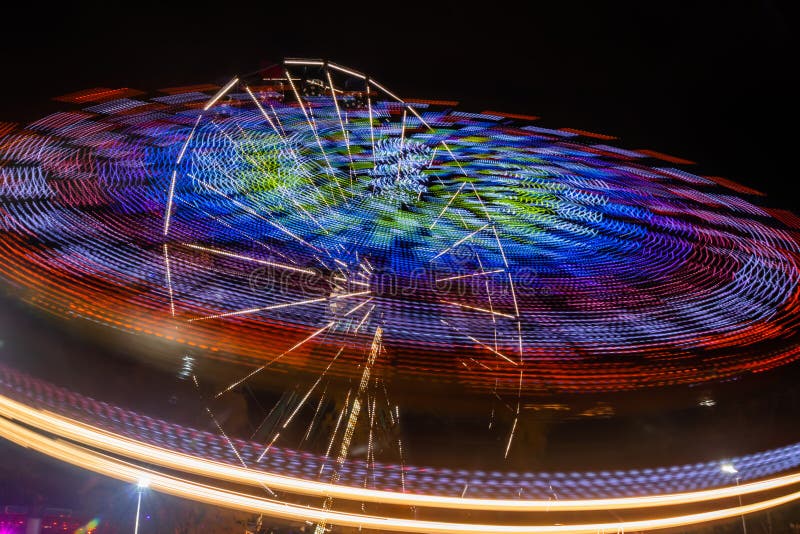 Two Rides in Motion in Amusement Park, Night Illumination. Long ...