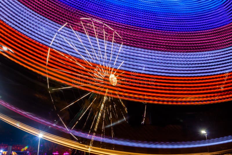 Two Rides in Motion in Amusement Park, Night Illumination. Long ...