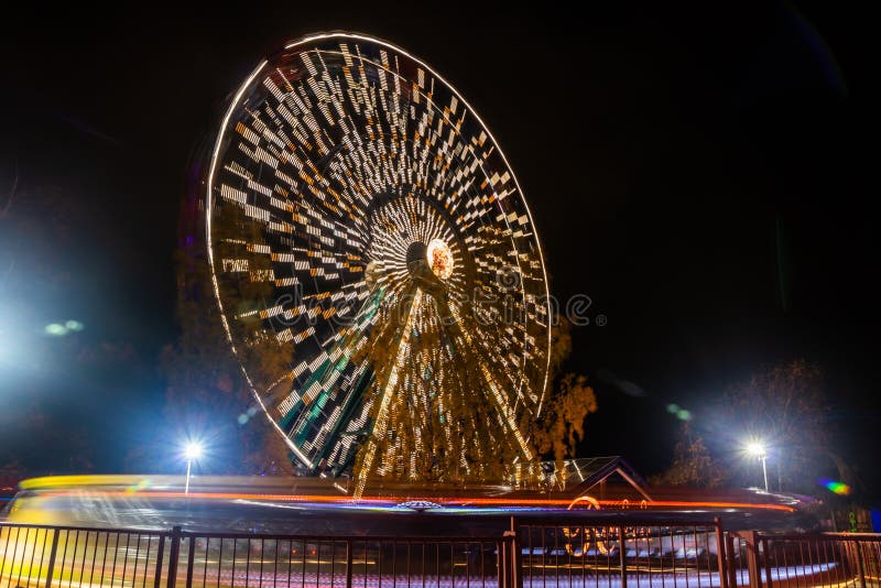 Two Rides in Motion in Amusement Park, Night Illumination. Long ...