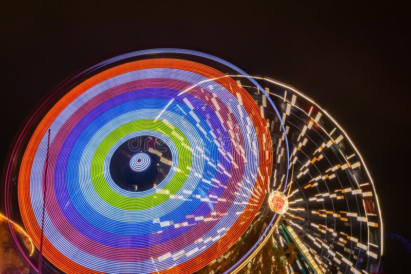 Two Rides in Motion in Amusement Park, Night Illumination. Long ...