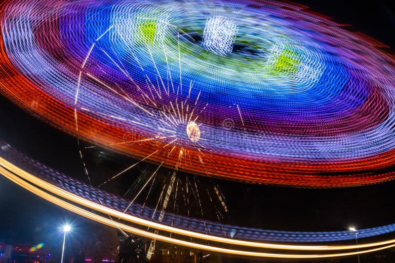 Two Rides in Motion in Amusement Park, Night Illumination. Long ...