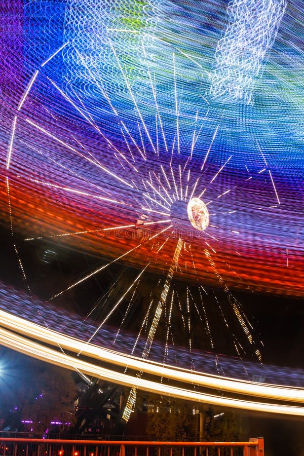 Two Rides in Motion in Amusement Park, Night Illumination. Long ...