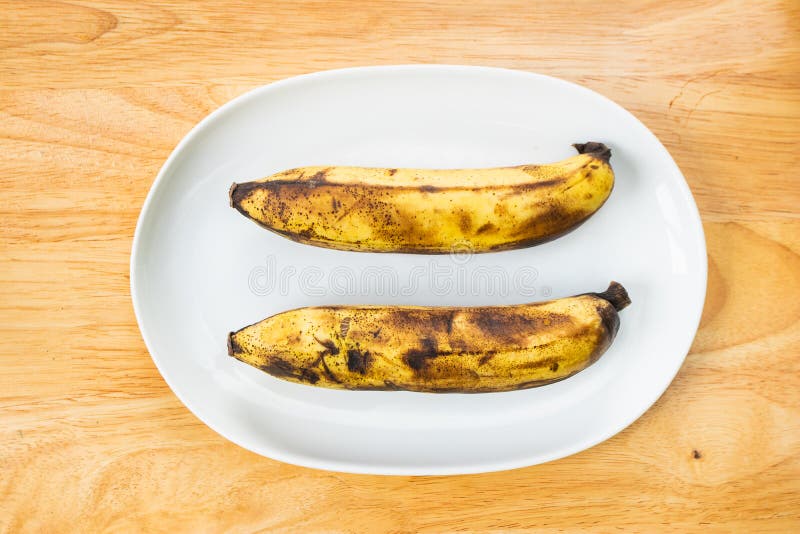 Two Ripe Bananas in a White Dish on the Wooden Table Stock Photo ...