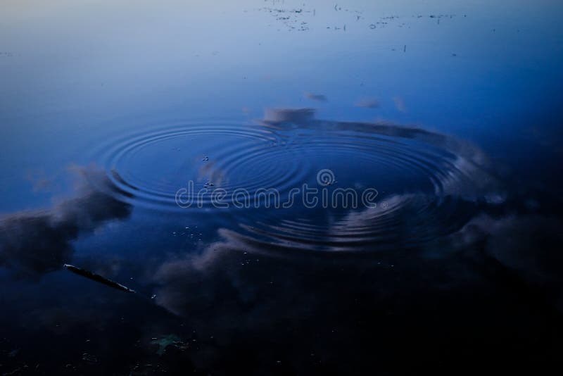 Two Ripples in a Blue Sky Lake Stock Photo - Image of splash, droplet ...