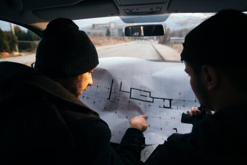 Two Robbers Planning and Pointing on the Blueprint Map Their Objective ...
