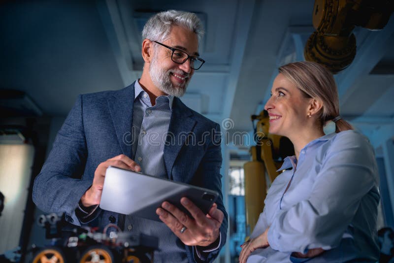 Two Robotics Engineers Working on New Project, Standing in Laboratory ...