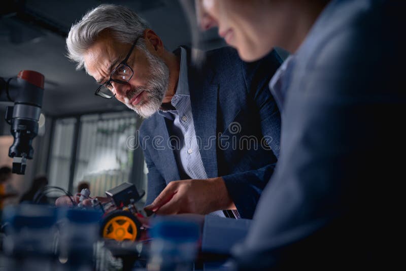 Two Robotics Engineers Working on New Project, Standing in Laboratory ...