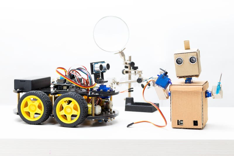 Two Robots Stand on the Table. Robot Holds Servo and Prop Stock Photo ...