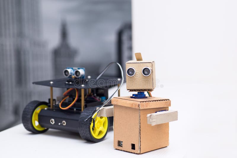 Two Robots are on the Table on a White Table Home Stock Photo - Image ...