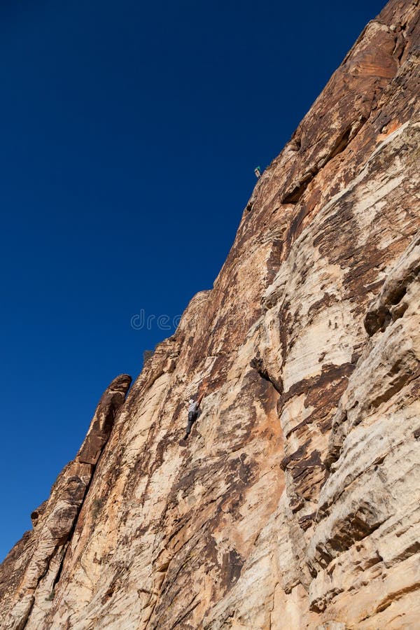 Two Rock Climbers High on a Cliff Stock Photo - Image of outdoor ...