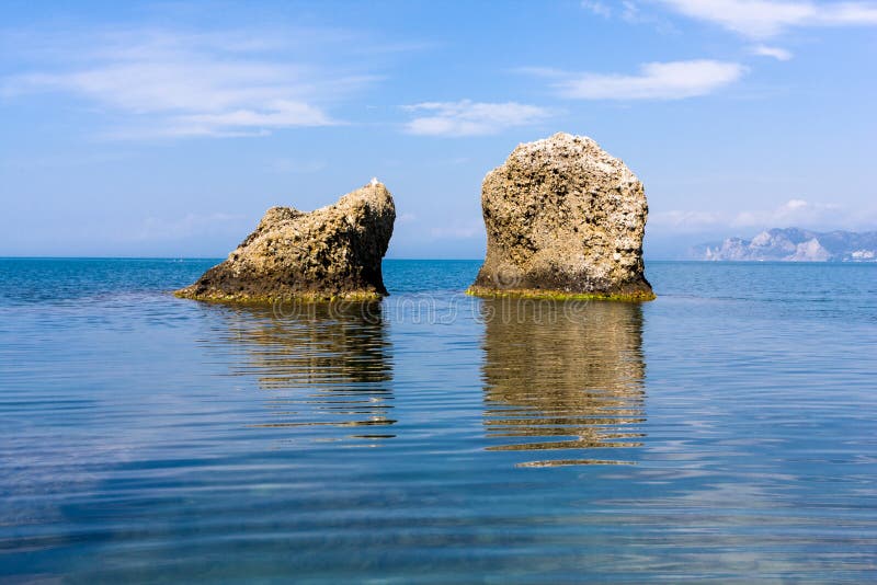 Two rocks in sea water stock photo. Image of outdoor - 73861098