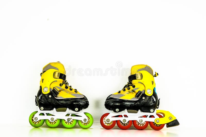 Two Roller Skates with Green, Yellow and Red Wheels Stock Photo - Image ...