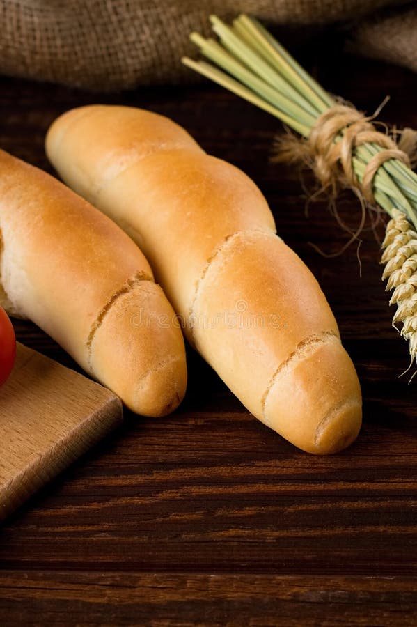Two rolls on wooden board stock image. Image of bake - 58330539