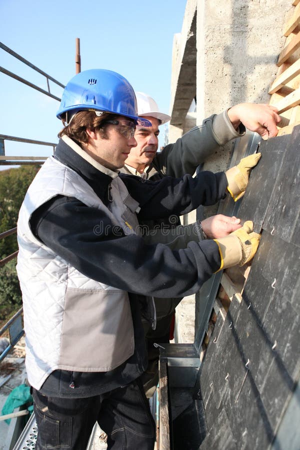 Two roofers at work stock image. Image of cladding, insulation - 16264003