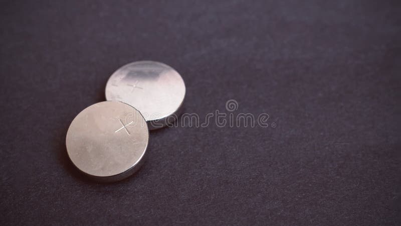 Two Round Batteries on a Black Background Stock Image - Image of volt ...