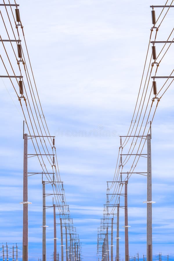 Two Rows of Electric Poles with Cable Lines Against White Cloudy on ...