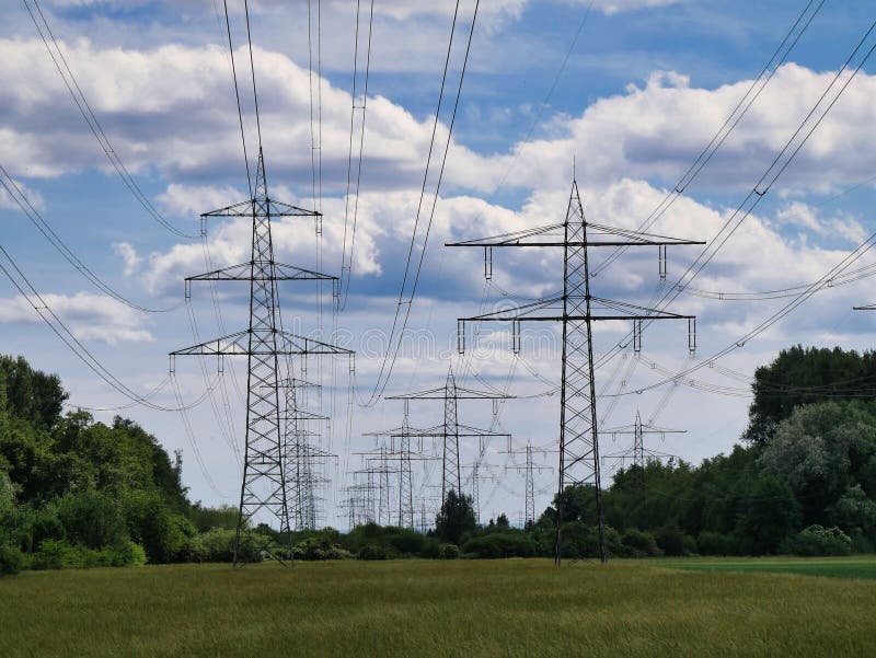 Rows of Electrical Transmission Towers on a Field Stock Image - Image ...