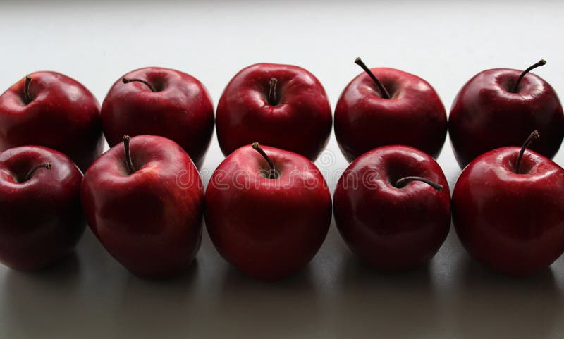 Two Rows of Fresh Red Apples on White Surface Closeup Angle View Stock ...