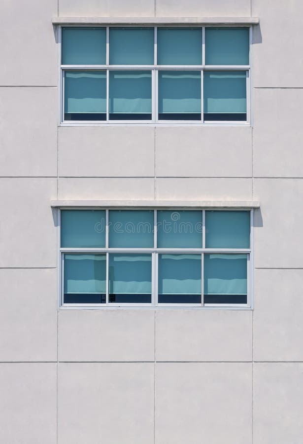 Two Rows of Glass Windows on Large Square Concrete Tiles Wall of Office ...